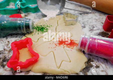 Red and green Sprinkles spilling out onto sugar cookie dough Stock ...