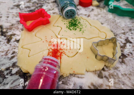 Red and green Sprinkles spilling out onto sugar cookie dough Stock ...