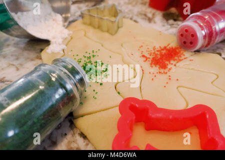 Red and green Sprinkles spilling out onto sugar cookie dough Stock ...