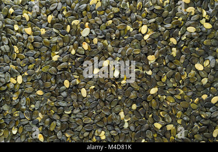 pumpkeen seeds scattered over stone board Stock Photo - Alamy