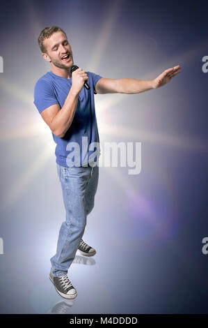 Young handsome man singing karaoke at home Stock Photo - Alamy