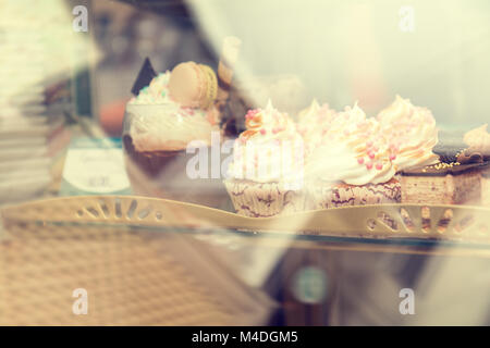 Cupcakes with vanilla cream on showcase Stock Photo - Alamy
