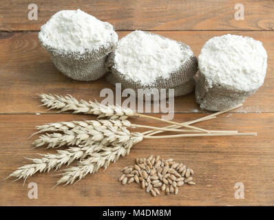 Wooden spoon with flour wheat ear on black background Stock Photo - Alamy