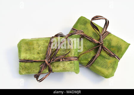 Many small green gift boxes on texture background of fashion trendy ...