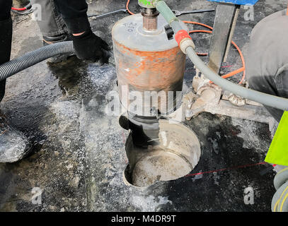 Construction worker drilling into concrete ceiling Stock Photo ...