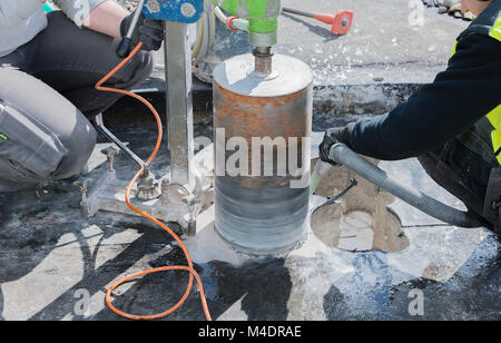 Construction worker drilling into concrete ceiling Stock Photo ...
