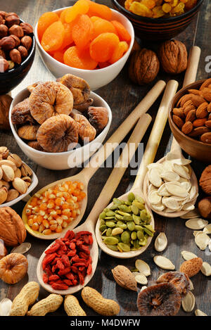 Dried fruits and assorted nuts on a white wooden table Stock Photo - Alamy