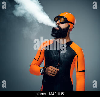 Bearded scuba diver male in orange neoprene suit isolated on grey Stock ...