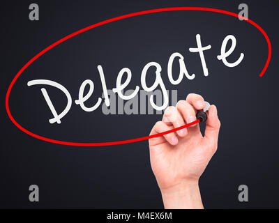Man Hand writing Delegate black marker on visual screen. Isolated on ...