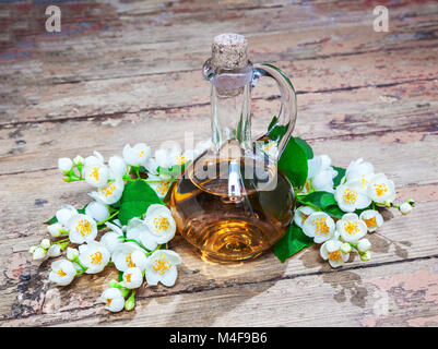 Oil of jasmine. Aromatherapy with jasmine oil. Jasmine flowers. Wooden ...