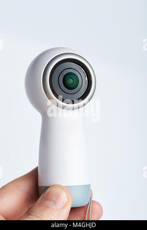 Modern 360 camera in hand close-up view isolated on white background ...
