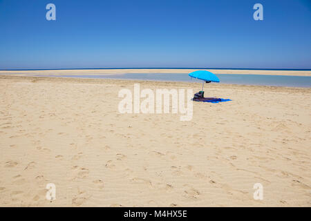 Desert beach with sun shades, tranquil sea, blue sky, clouds . Summer ...