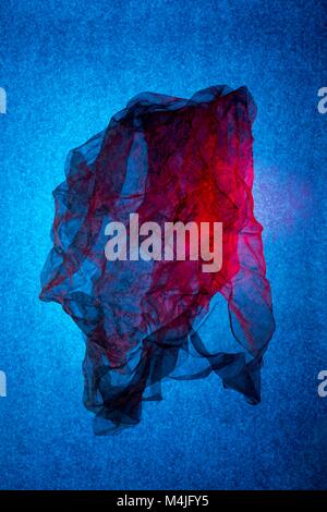Transparent thin handkerchief on a blue background Stock Photo - Alamy