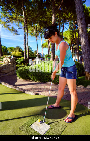 Close-up of miniature golf hole with bat and ball Stock Photo - Alamy