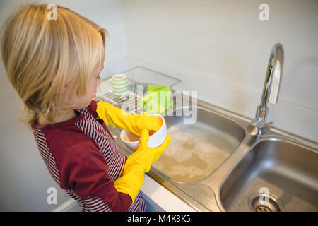 Boy washing utensil in kitchen Stock Photo - Alamy