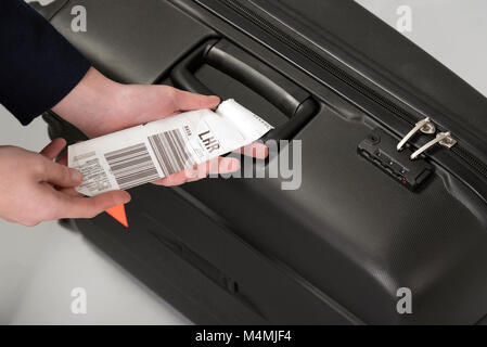A suitcase with a airline barcode baggage tag from London Heathrow (LHR ...