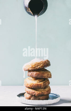 Danish cinnamon bun on a white plate Stock Photo - Alamy
