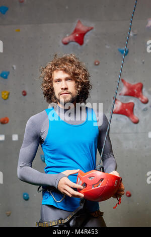 Caucasian athlete climber man with bare body exercising on grey ...