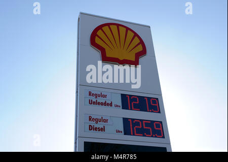 Logos of the oil and gas company Royal Dutch Shell on a heap on a table ...