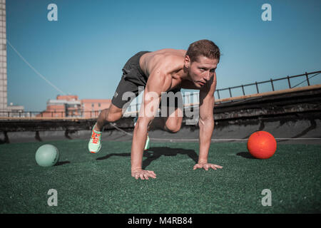 Young man doing sport exercises in the morning Stock Photo - Alamy