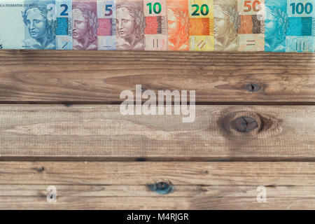 brazilian money all denominations on the wooden background with place ...