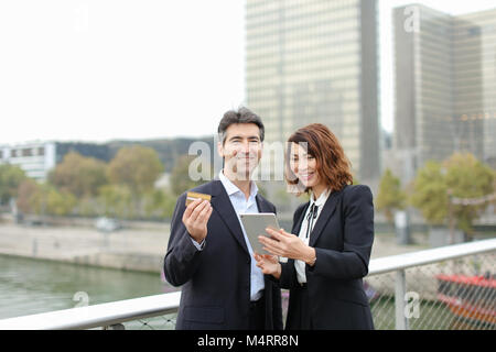 Married business couple make purchases by credit card Stock Photo - Alamy