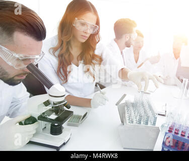 Man and woman scientists partners using microscope working at laboratory Stock Photo - Alamy