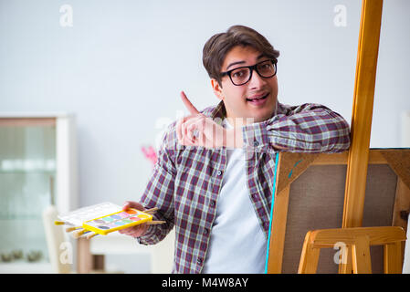 The young male artist drawing pictures in bright studio Stock Photo - Alamy