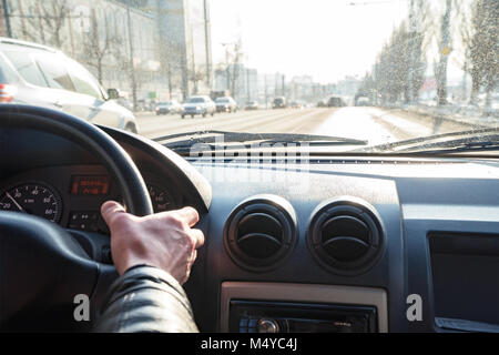 Wheel and dashboard of a car and view through the windshield on the ...