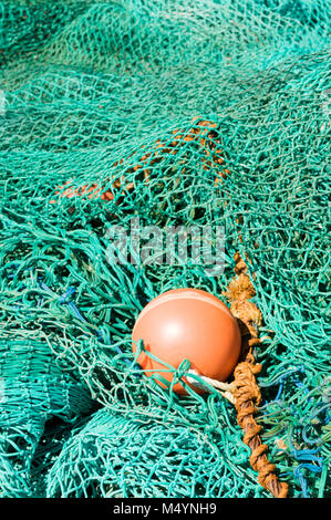 turquoise blue and orange fishing net Stock Photo - Alamy