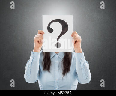 Woman holding interrogation symbol in front of her face. Female ...