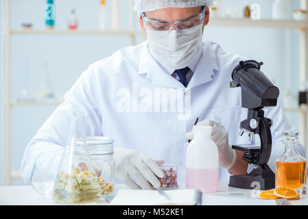 Chemist mixing perfumes in the lab Stock Photo - Alamy