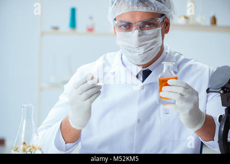 Chemist mixing perfumes in the lab Stock Photo - Alamy