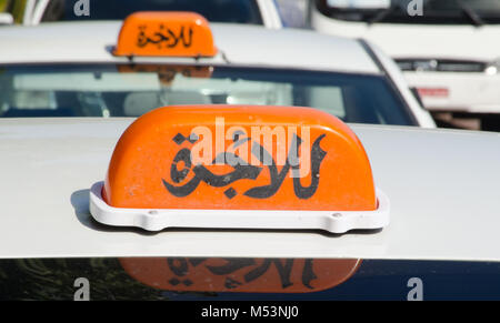Taxi signs in English and Arabic in the Arabian Gulf Stock Photo - Alamy