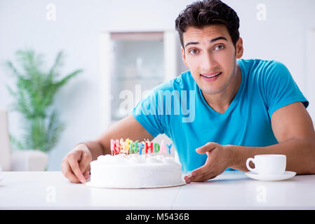 Young man celebrating birthday alone at home Stock Photo - Alamy
