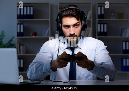 The businessman gamer staying late to play games Stock Photo - Alamy