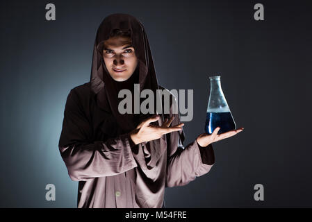 Alchemist doing experiments in alchemy concept Stock Photo - Alamy