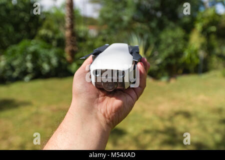 A DJI Mavic Air drone folded in a mans hand to show the size of the ...