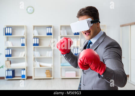 Man boxing in the office with virtual reality goggles Stock Photo - Alamy