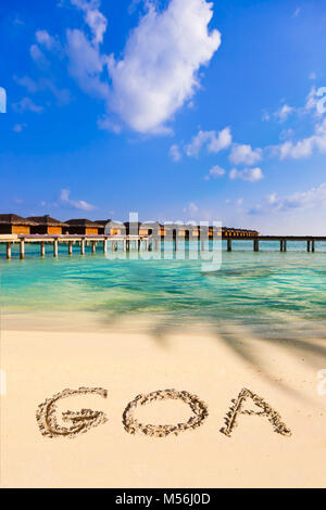 Text GOA on the sand on the beach on the background of blue sea and ...