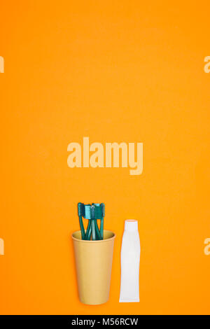 Toothbrushes and a tube of toothpaste in a cup isolated on white Stock ...
