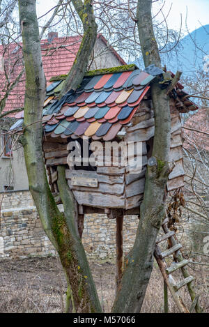 Wooden house with trees around it in sunny day Stock Photo - Alamy