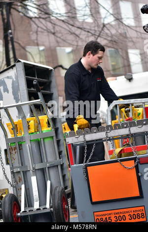 A worker loading & unloading oxygen cylinders at a government hospital ...