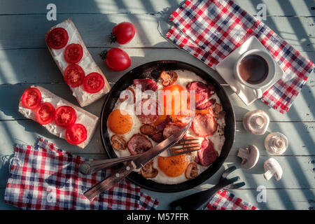 Top view of fried eggs with sausage, bread and vegetable Stock Photo ...