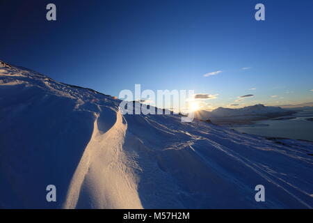 Sun Burst Over Mountain , Snow Drift Foreground Stock Photo - Alamy