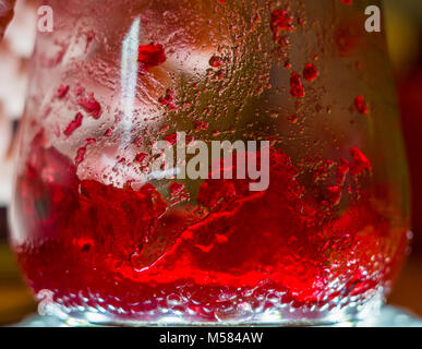 Bright translucent red currant jam in a glass jar, close-up, macro ...