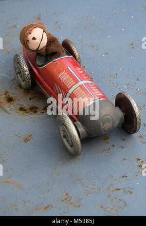 Racing driver sitting in a grey 1960s Porsche 911 in the pit lane at ...