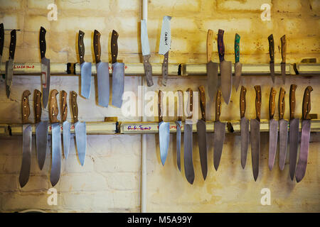 Knives with shaped wooden handles and a variety of shaped blades on ...