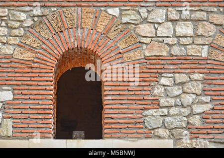Ancient Roman Arch in a mixed stone and brick wall Stock Photo - Alamy