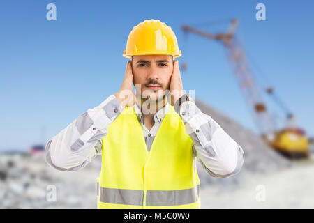 construction worker or engineer covering his ears Stock Photo - Alamy